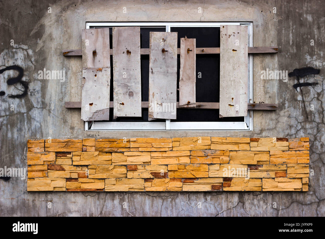 old urban window. locked with wood. window brick design Stock Photo - Alamy
