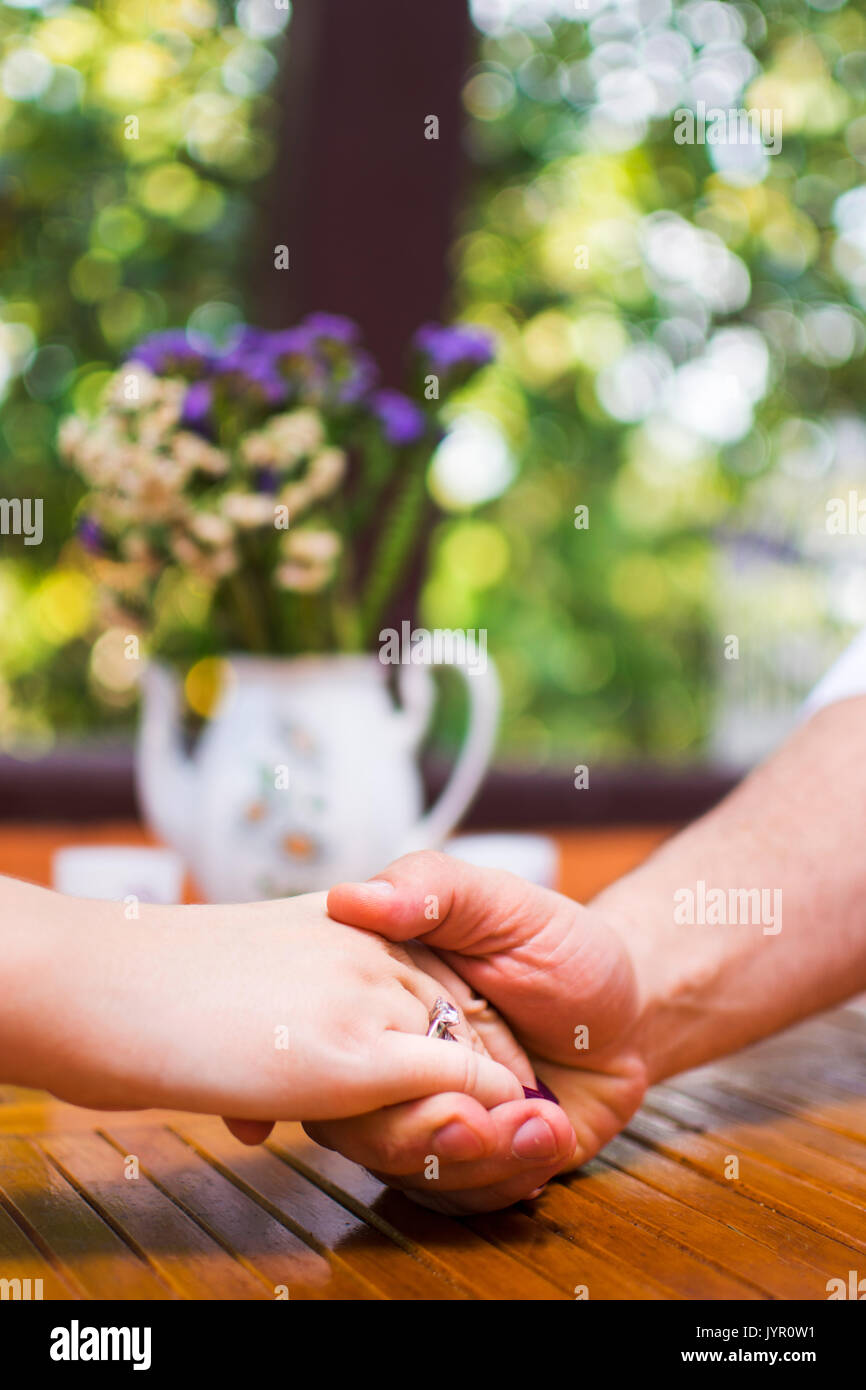 Couple holding hands on a romantic date Stock Photo - Alamy
