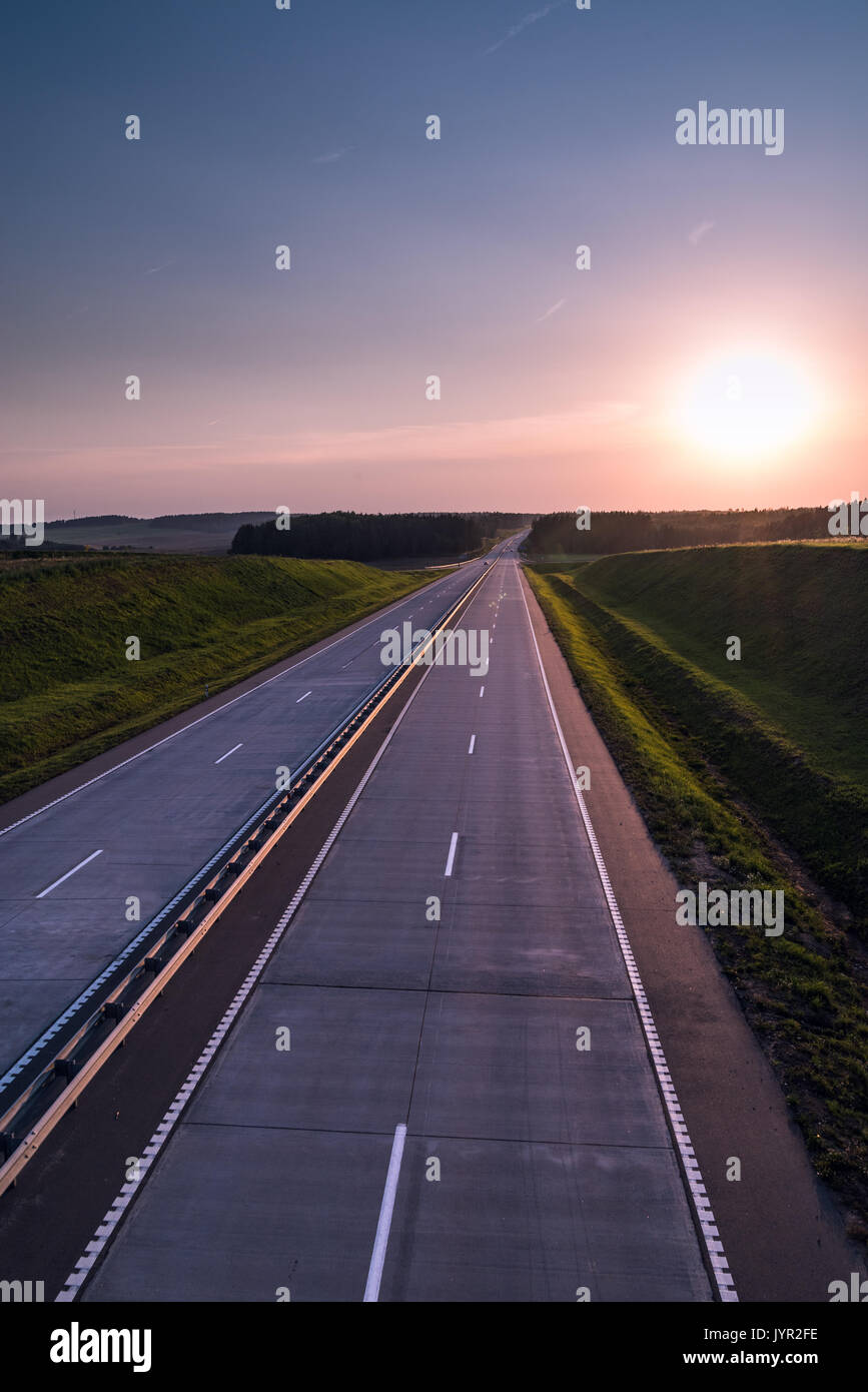 Country highway and sunset. Clear road great nature around. Verical ...