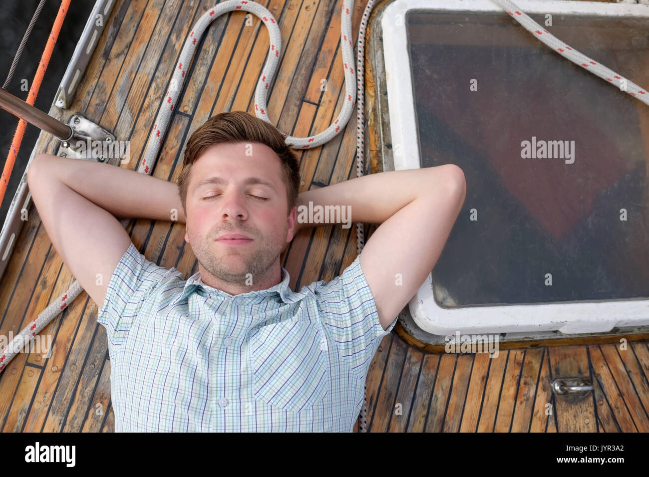 Man on deck. Resting on yacht duting vacation Stock Photo - Alamy