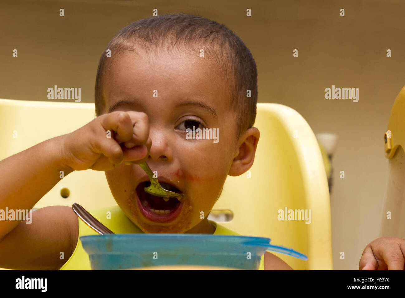 A Little b eating her dinner and making a mess Stock Photo - Alamy
