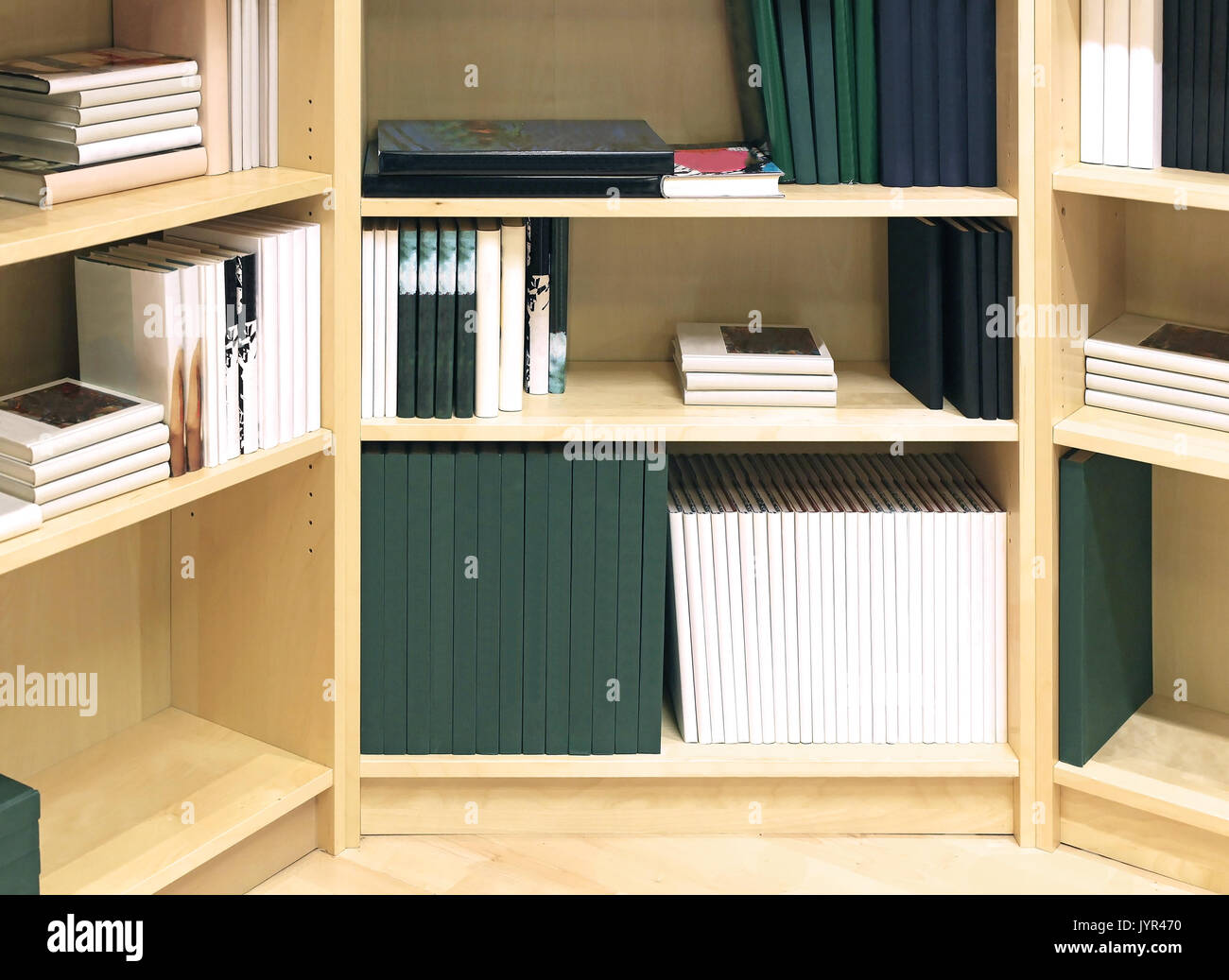 Modern wooden bookshelf detail with stack of books Stock Photo - Alamy