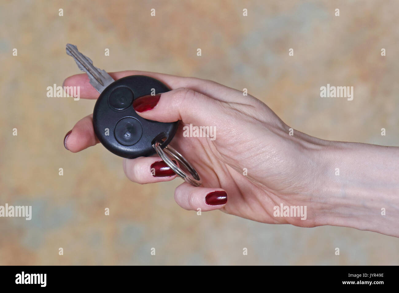 Female hand holding car key pressing remote control unlock button Stock ...