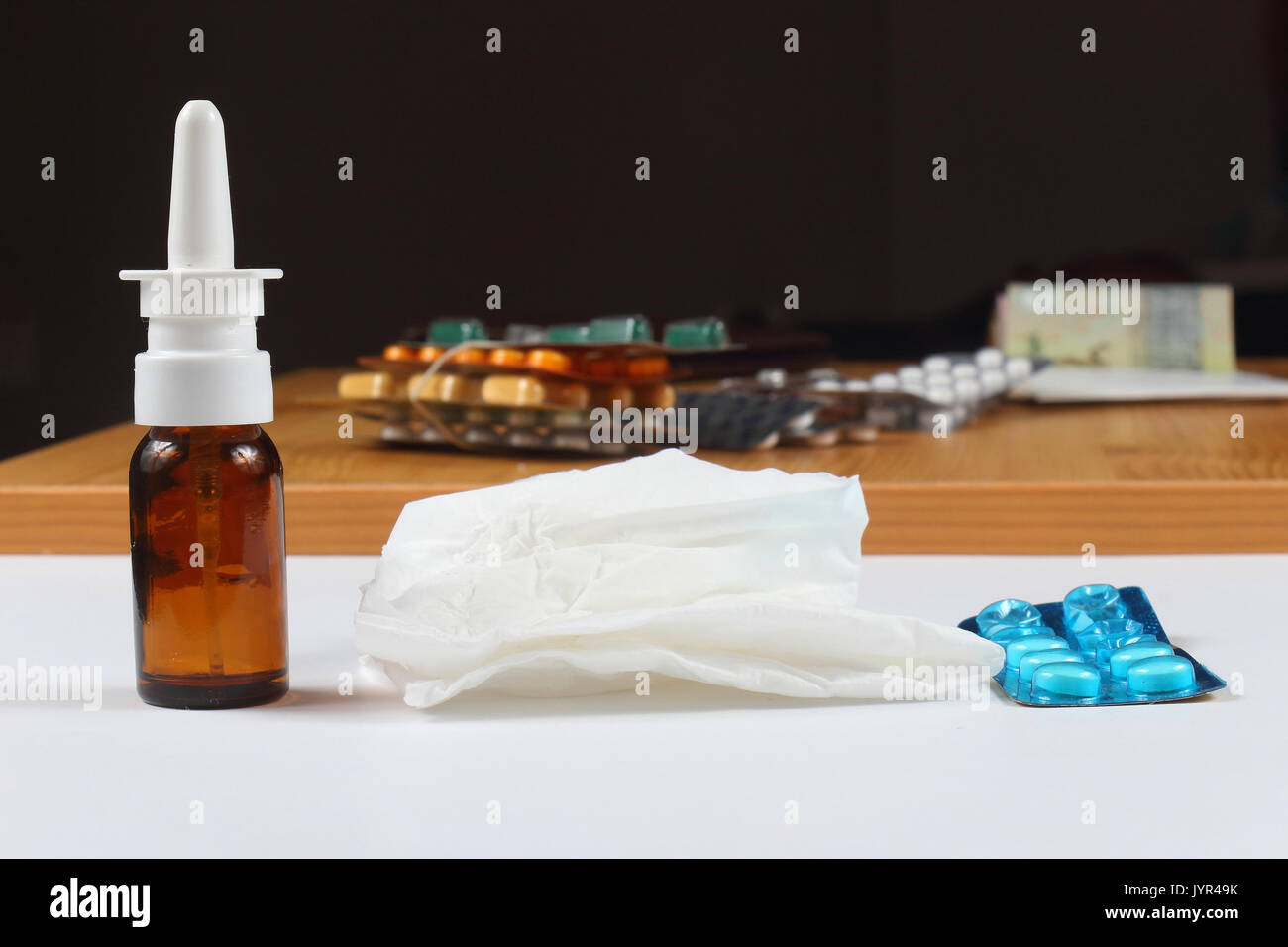 Paper tissue full with snivel and nose drops bottle Stock Photo - Alamy