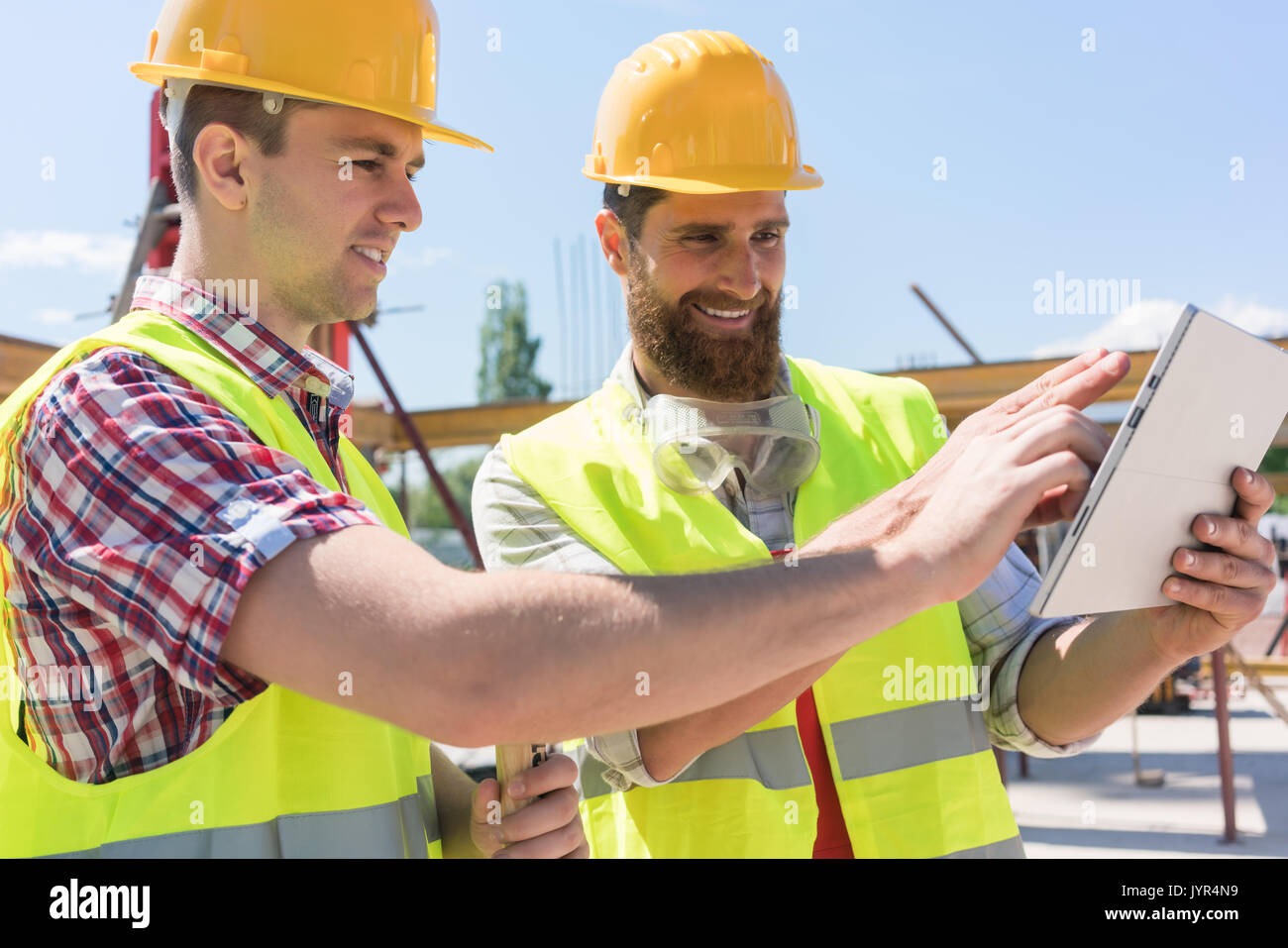 Two young workers watching a video or communicating online throu Stock ...