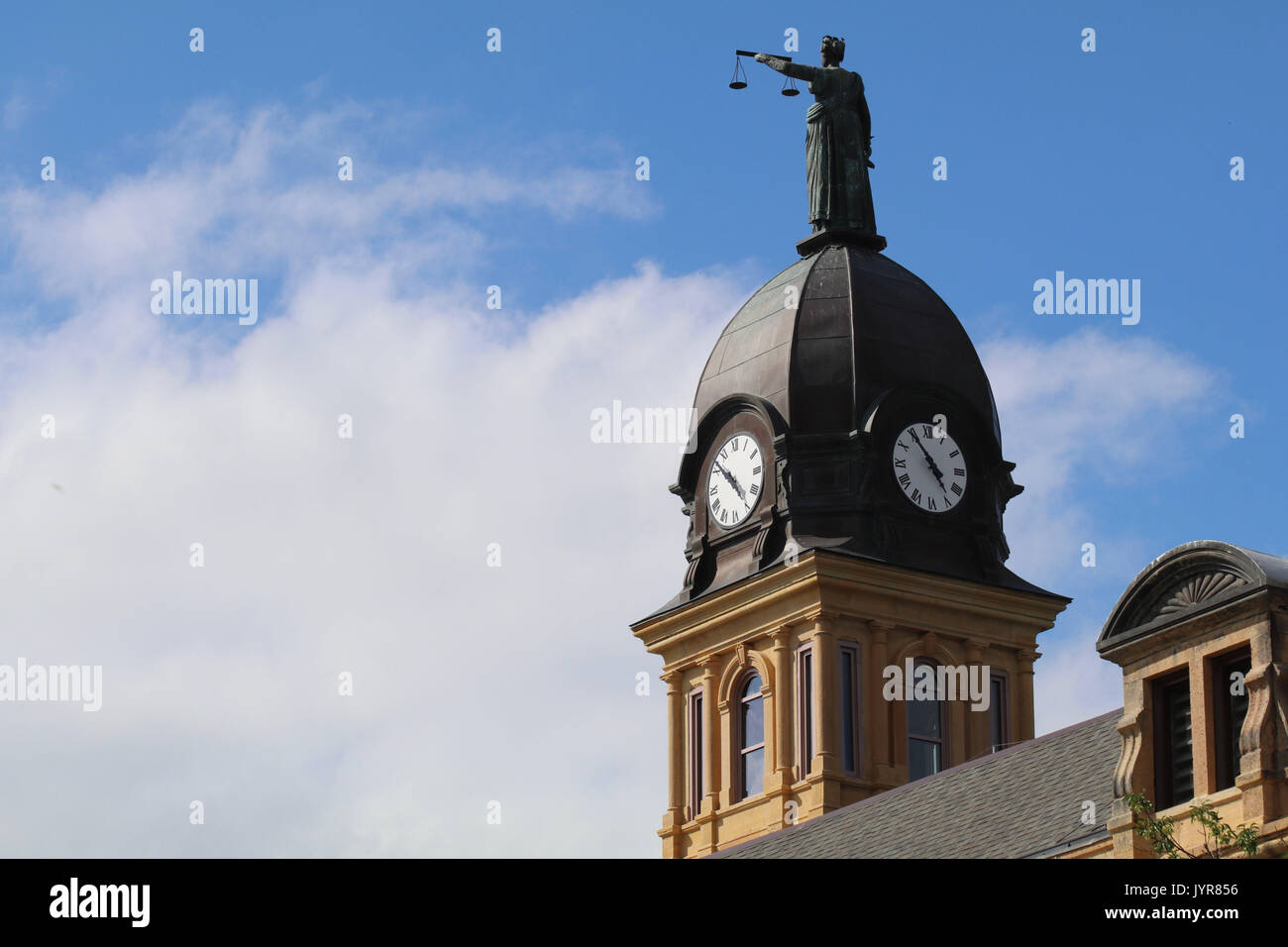 Lady justice clock tower with blue sky Stock Photo - Alamy