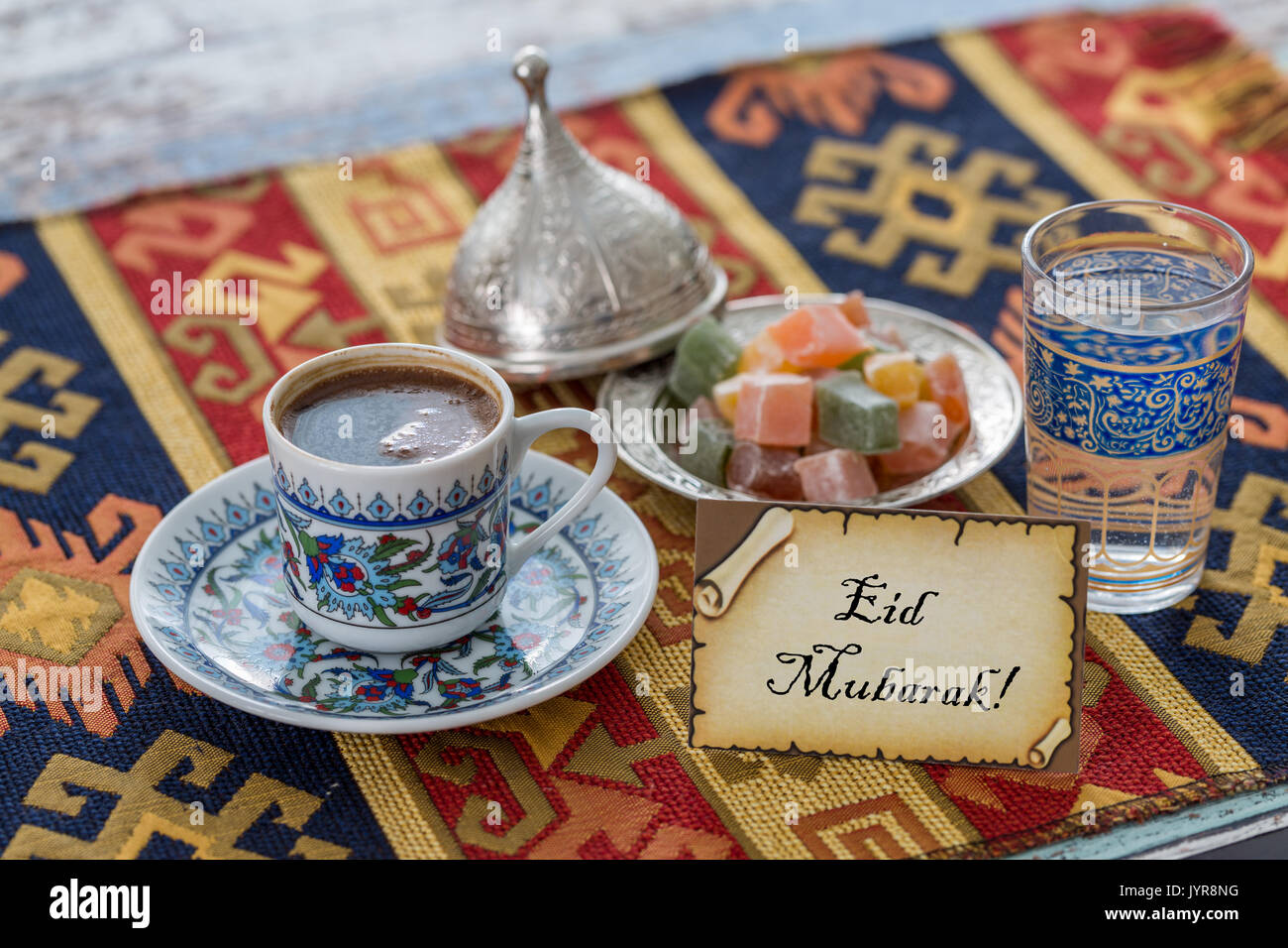 Eid mubarak text on greeting card with turkish coffee, delights on ...
