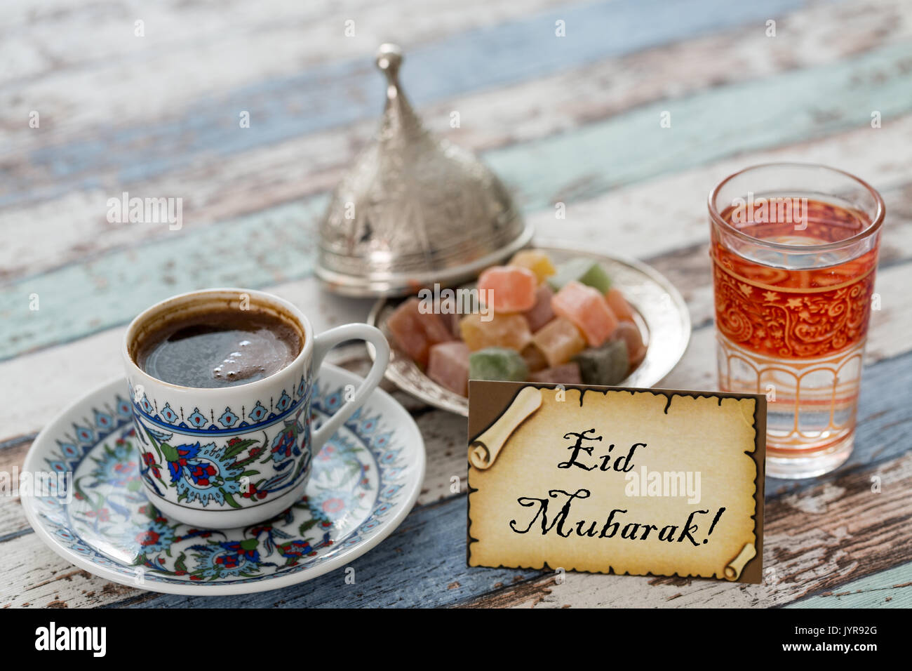 Eid mubarak text on greeting card with turkish coffee, delights on ...
