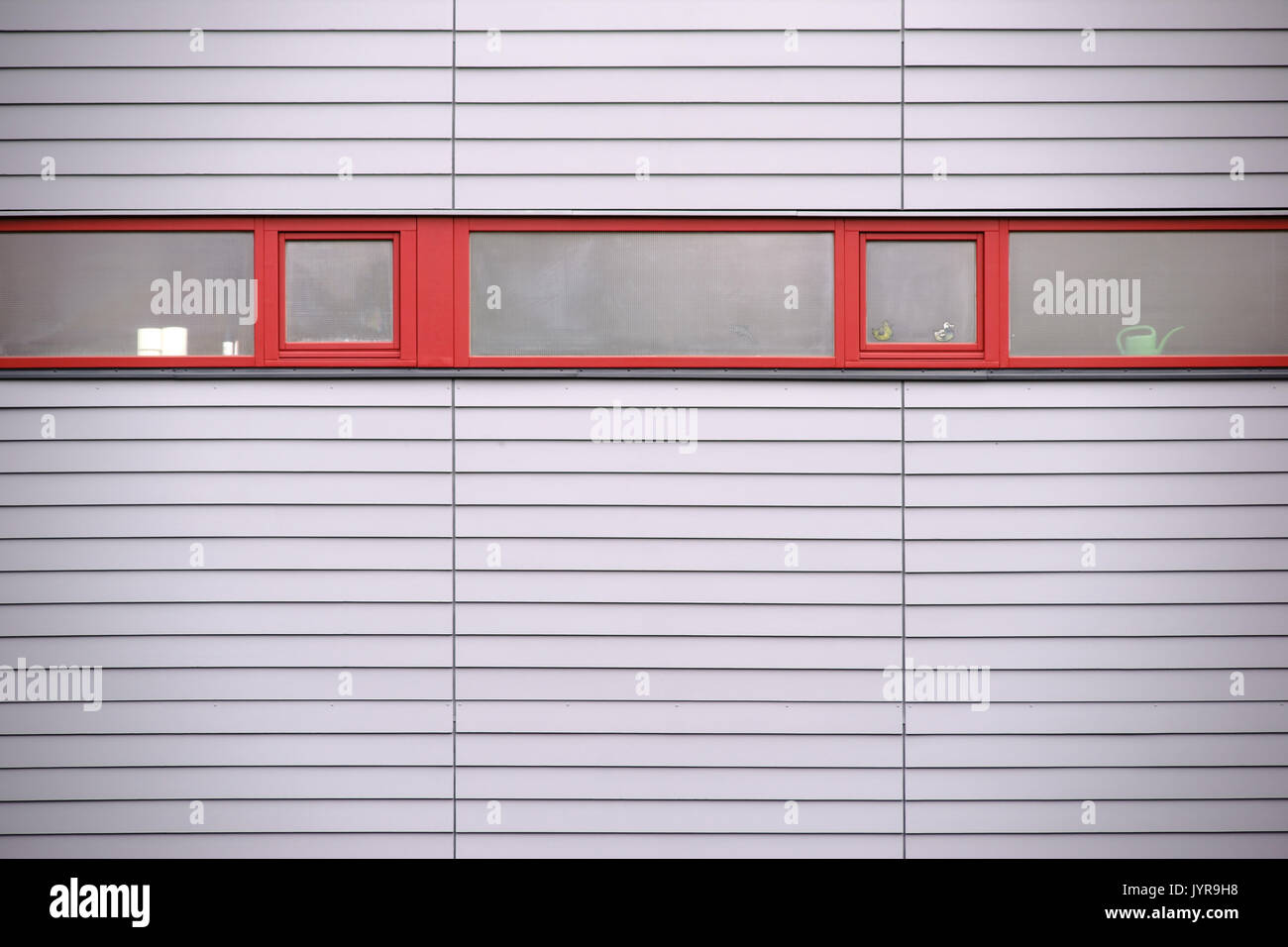 The narrow windows of a modern building with a modern wall covering ...