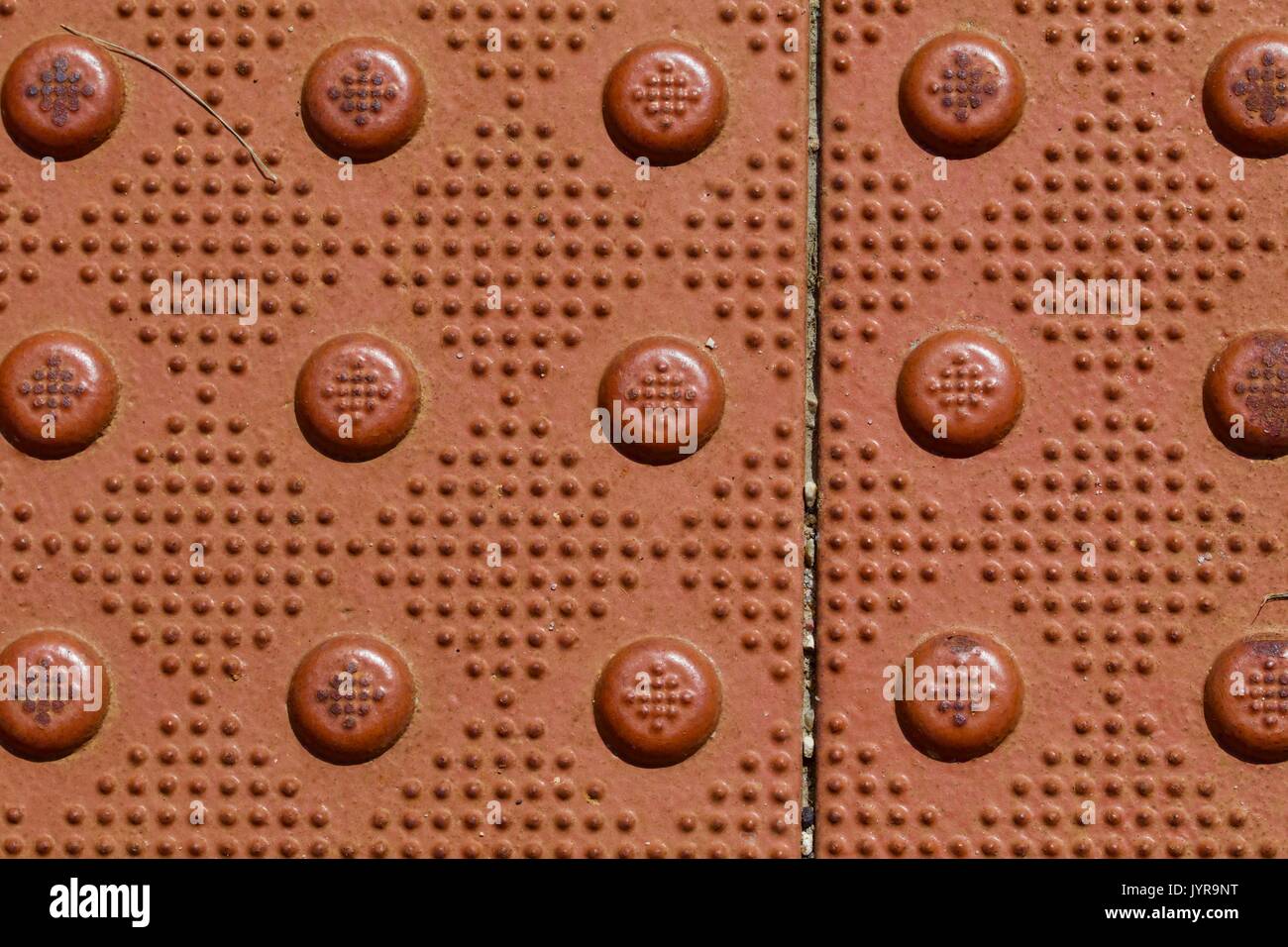 Pedestrian orange rubber foot grip for cross walk Stock Photo - Alamy
