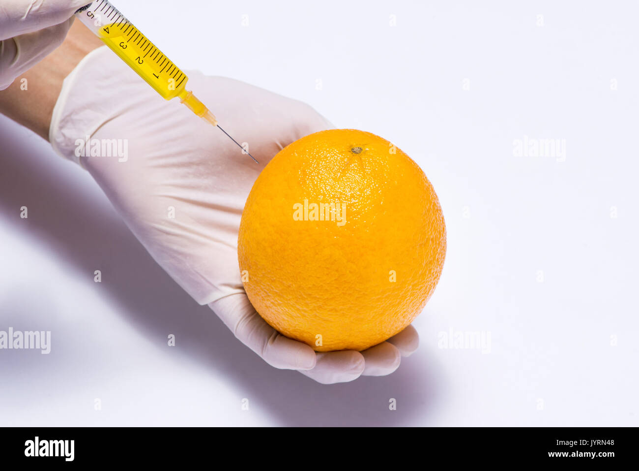 Science experiment with orange and syringe isolated on white Stock ...