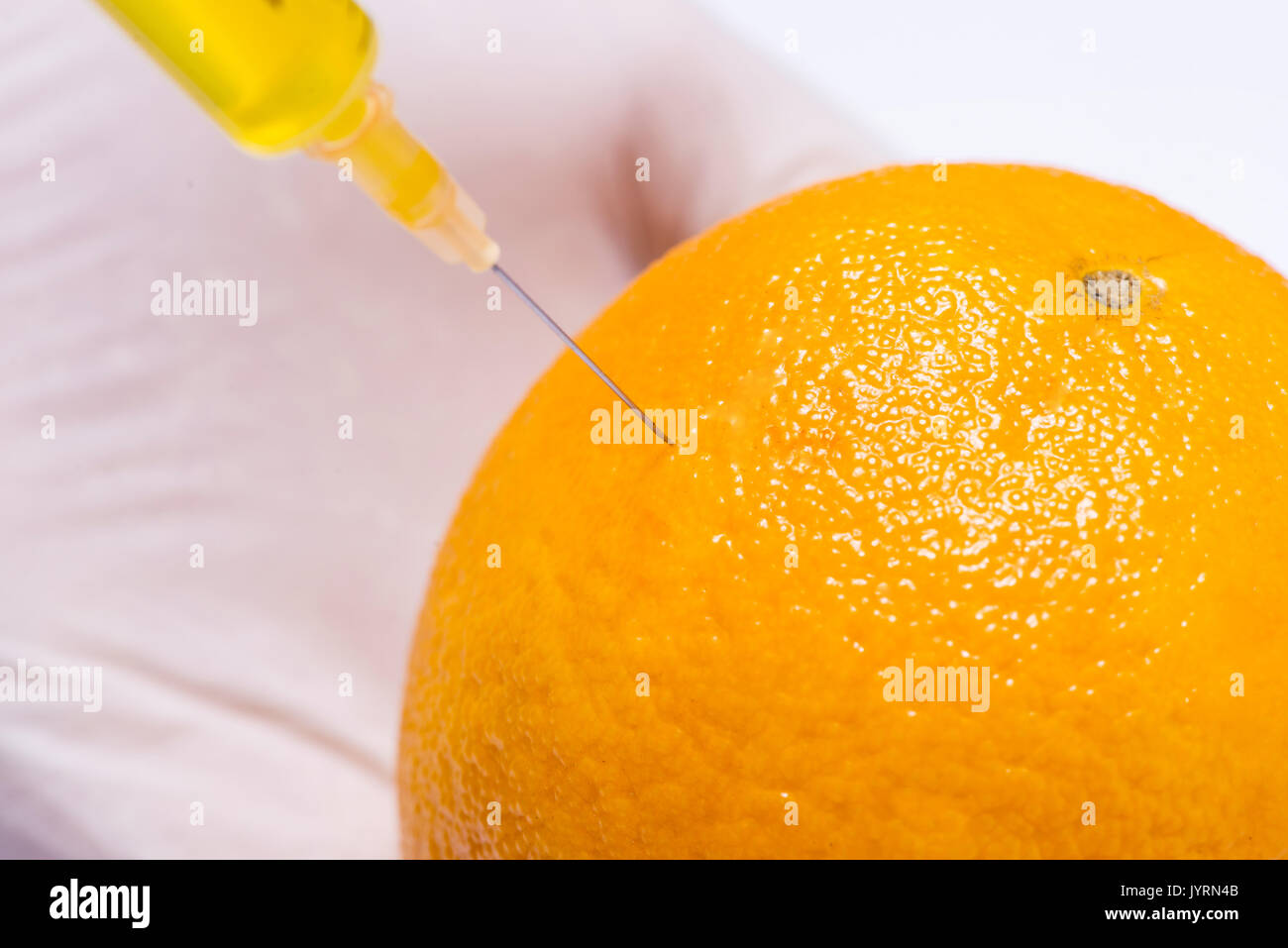 Science experiment with orange and syringe isolated on white Stock ...
