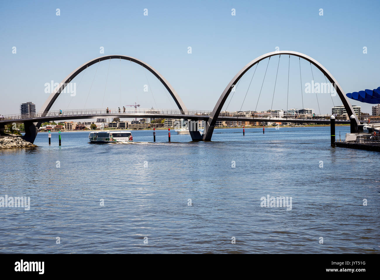A view of Elizabeth Quay Bridge and ferry sailing underneath in Perth ...