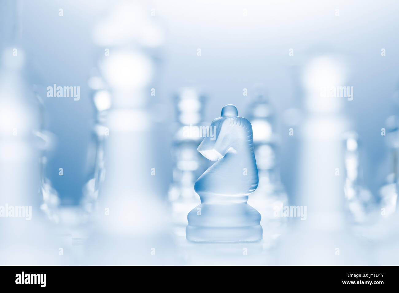Creative business concept photo of a transparent knight on a chessboard ...