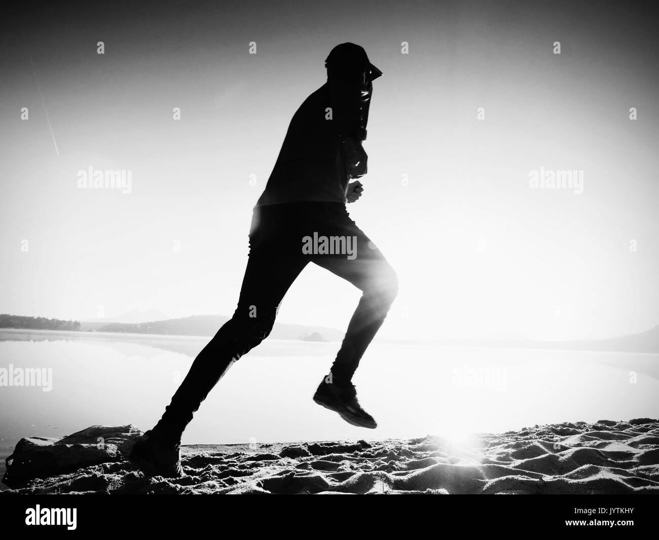 Slim young fitness man runner on beach, tropical trail runner. Cheerful ...