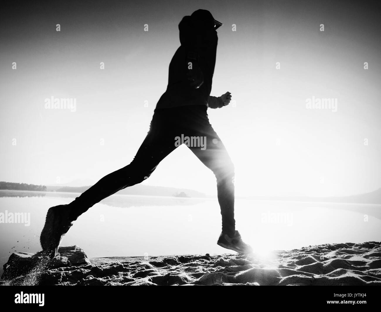 Slim young fitness man runner on beach, tropical trail runner. Cheerful ...