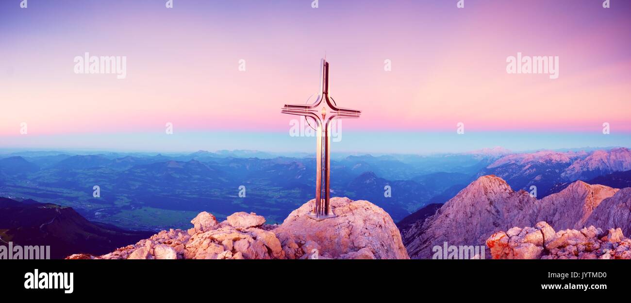 Watercolor paint effect. Steel crucifix at mountain peak in Alps. Sharp ...