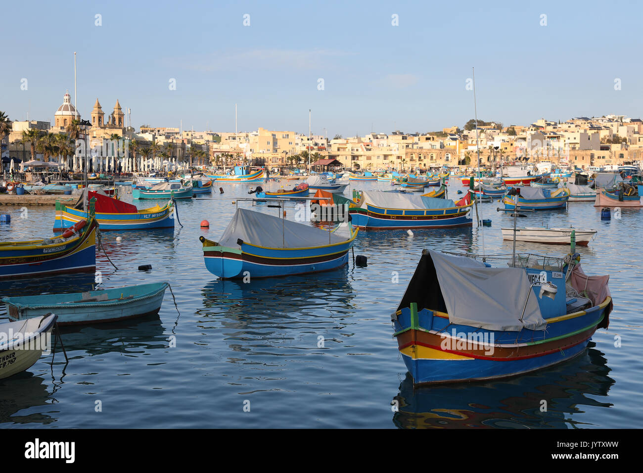 Traditional colorful fishing boats Luzzu moored at Marsaxlokk ...