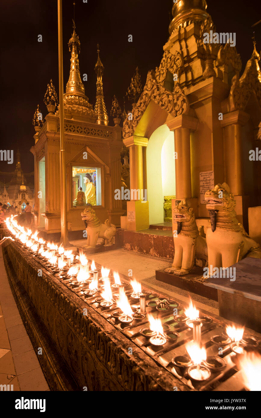 Yangon, Myanmar (Burma). Rows of candles in the Shwedagon pagoda at ...