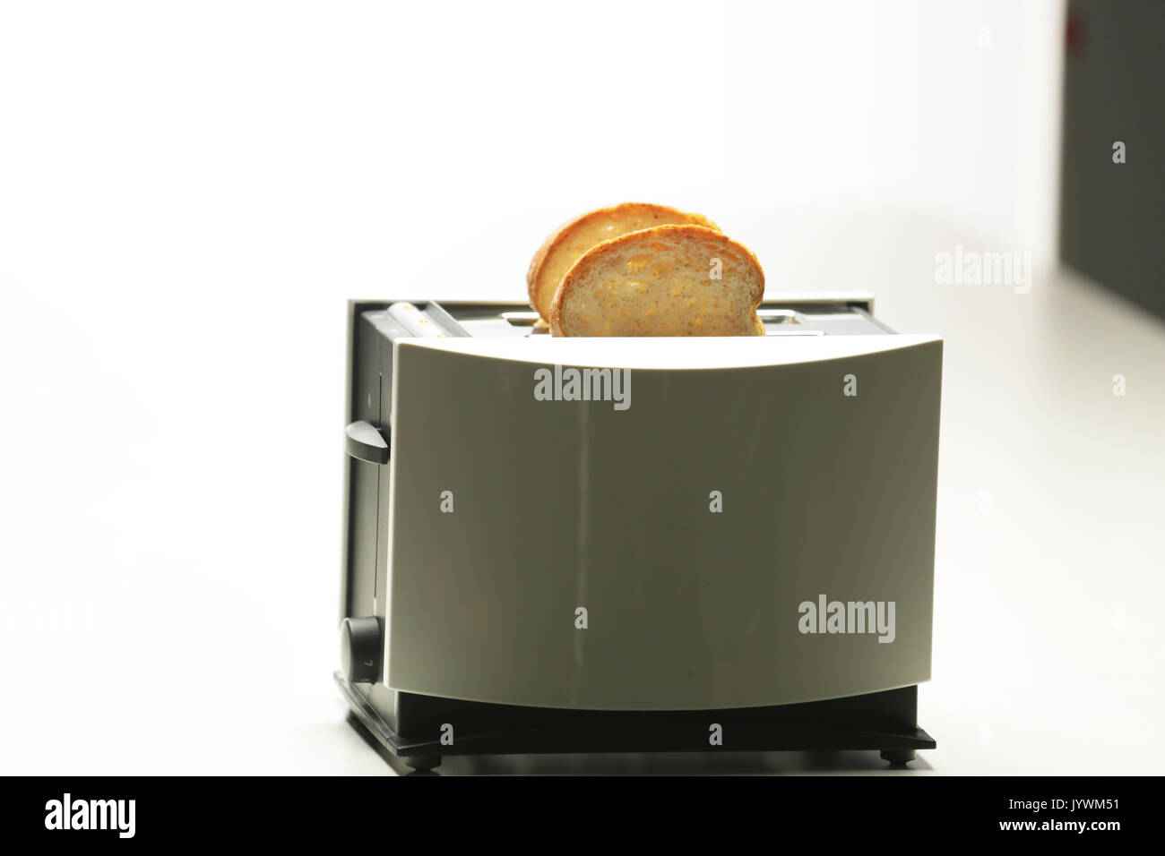 two breads put in a modern toaster Stock Photo - Alamy