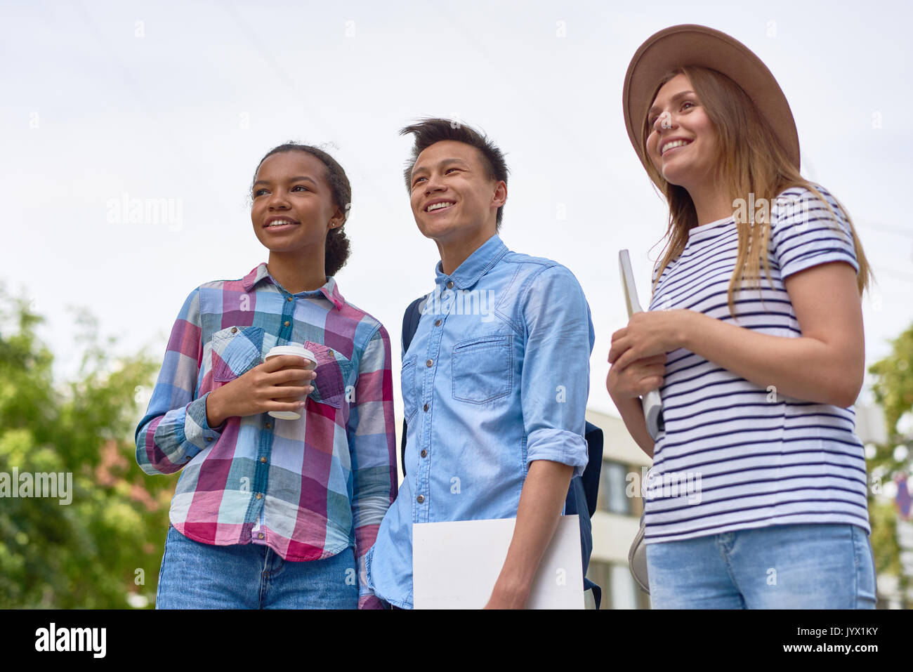 Three Joyful Students Outdoors Stock Photo - Alamy