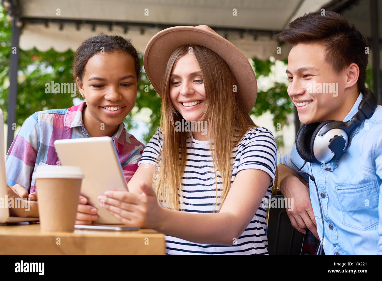 Modern Young People Using Computer Devices in Cafe Stock Photo - Alamy