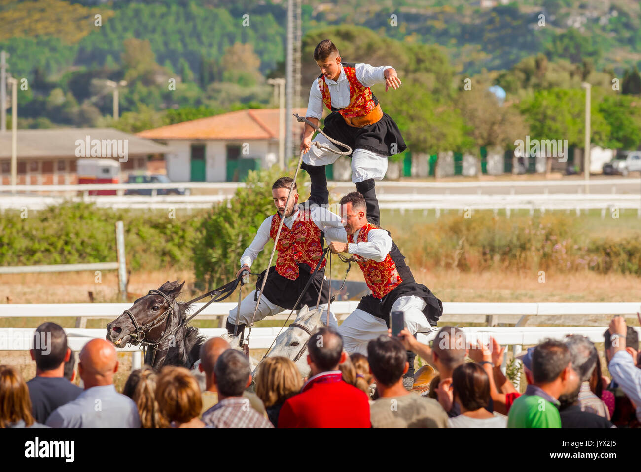 Sardinia horse riding, a three man team perform a traditional horse ...