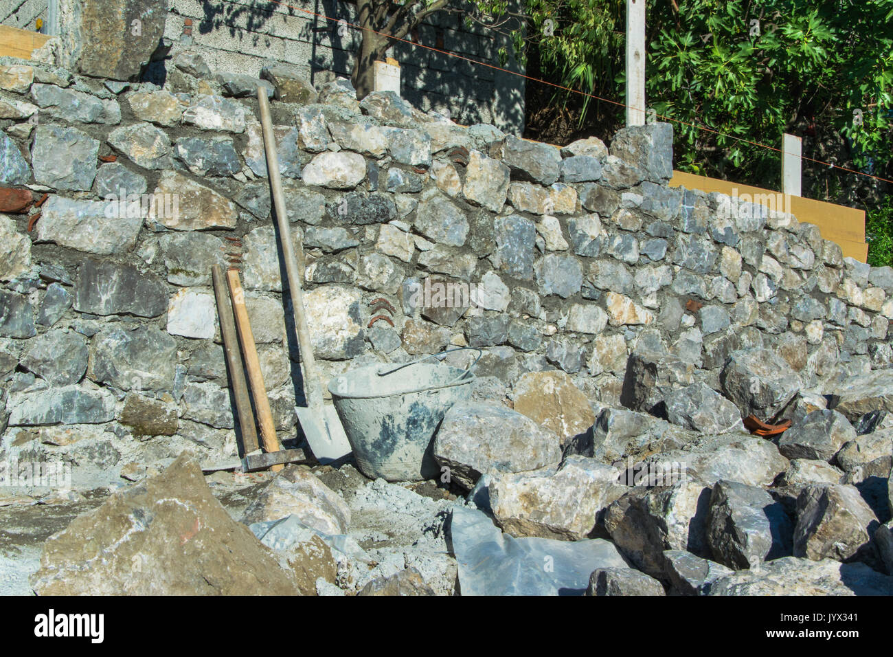 Stone wall construction Stock Photo - Alamy