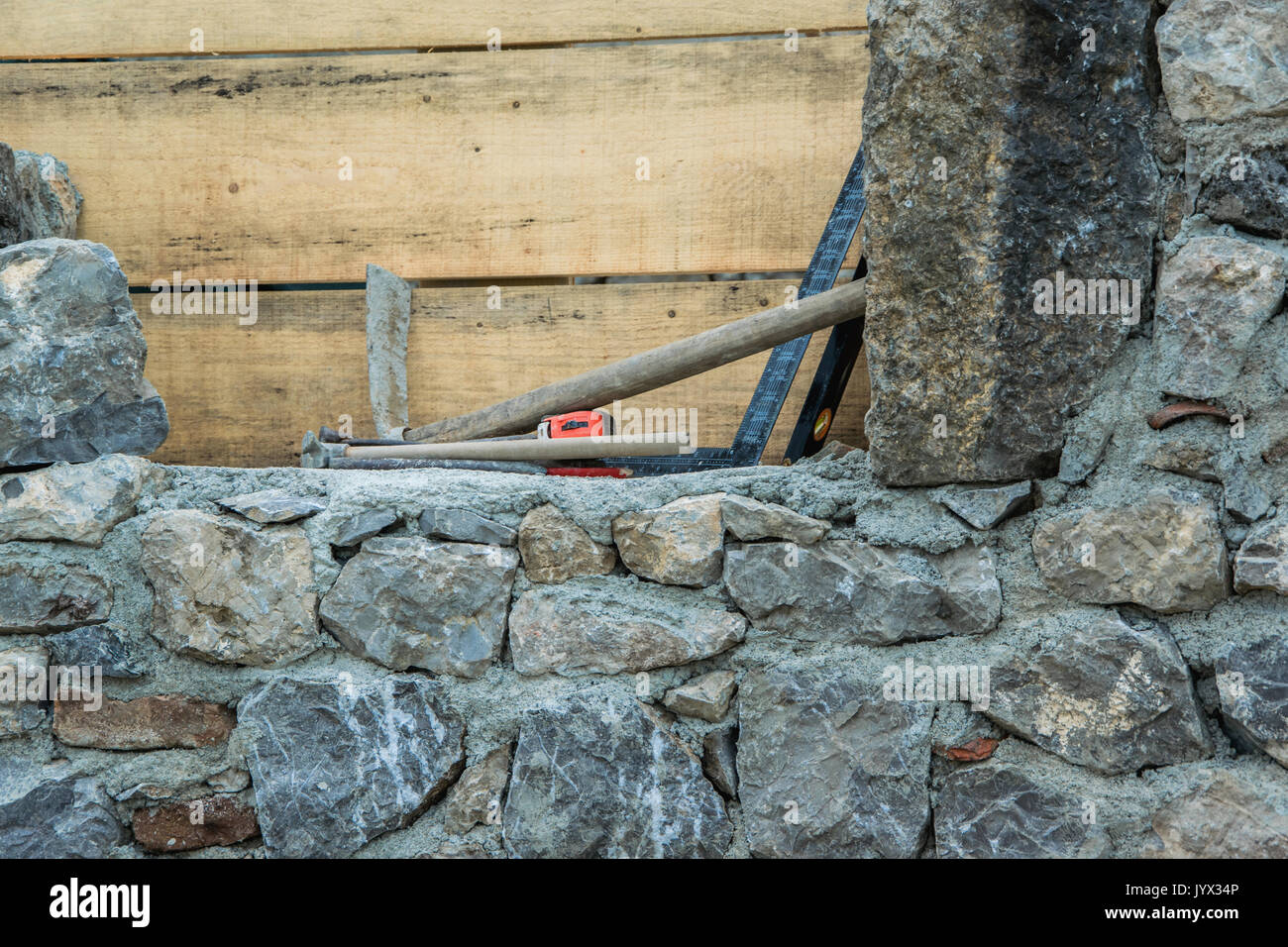 Stone wall construction Stock Photo - Alamy
