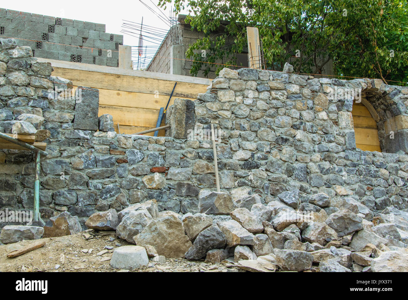 Stone wall construction Stock Photo - Alamy