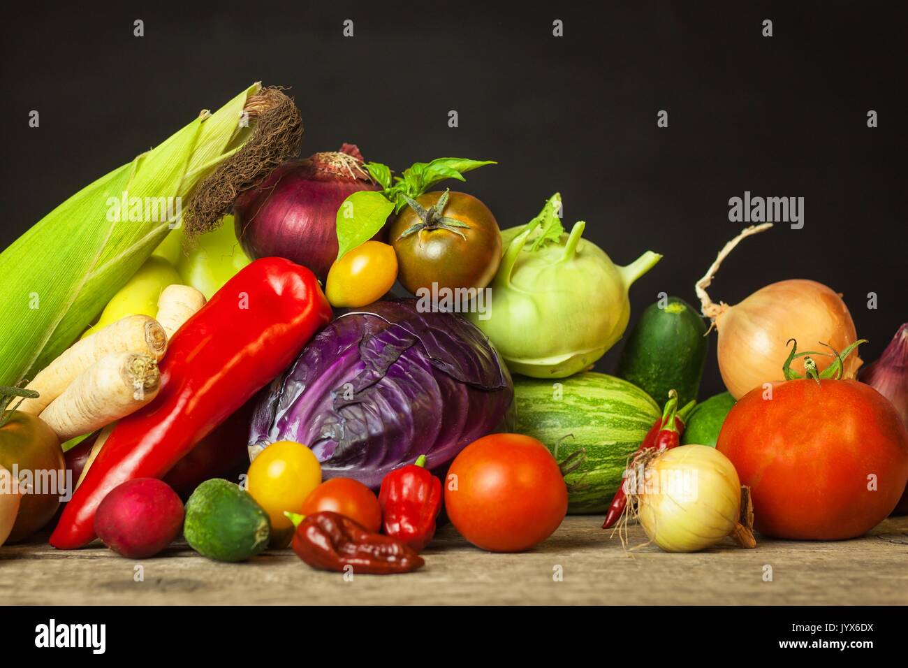 Different types of fresh vegetables on a wooden table. Harvesting ...