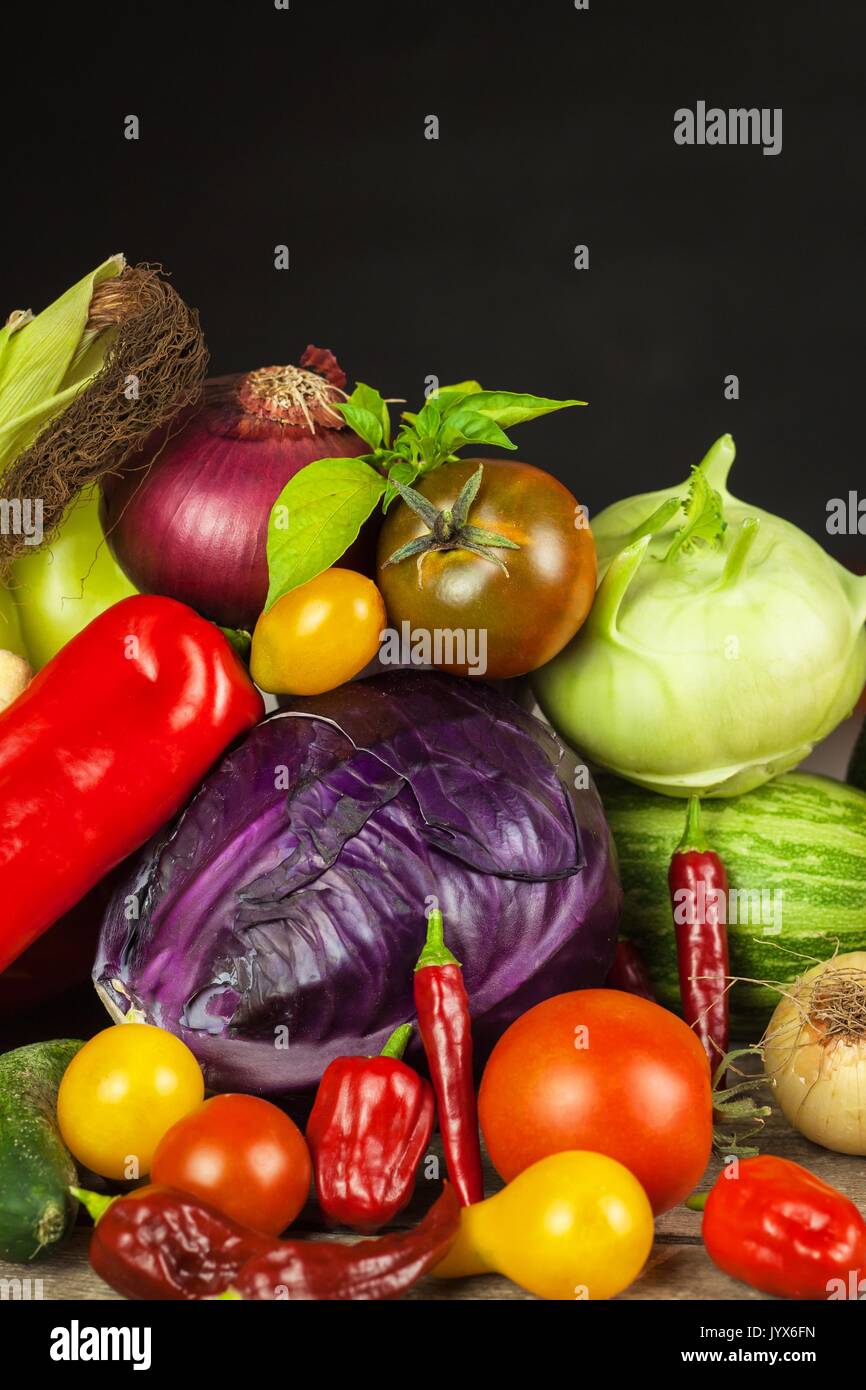 Different types of fresh vegetables on a wooden table. Harvesting ...