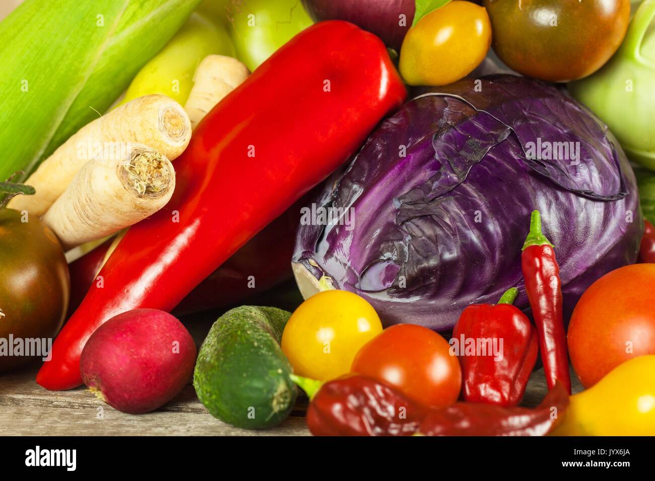 Different types of fresh vegetables on a wooden table. Harvesting ...