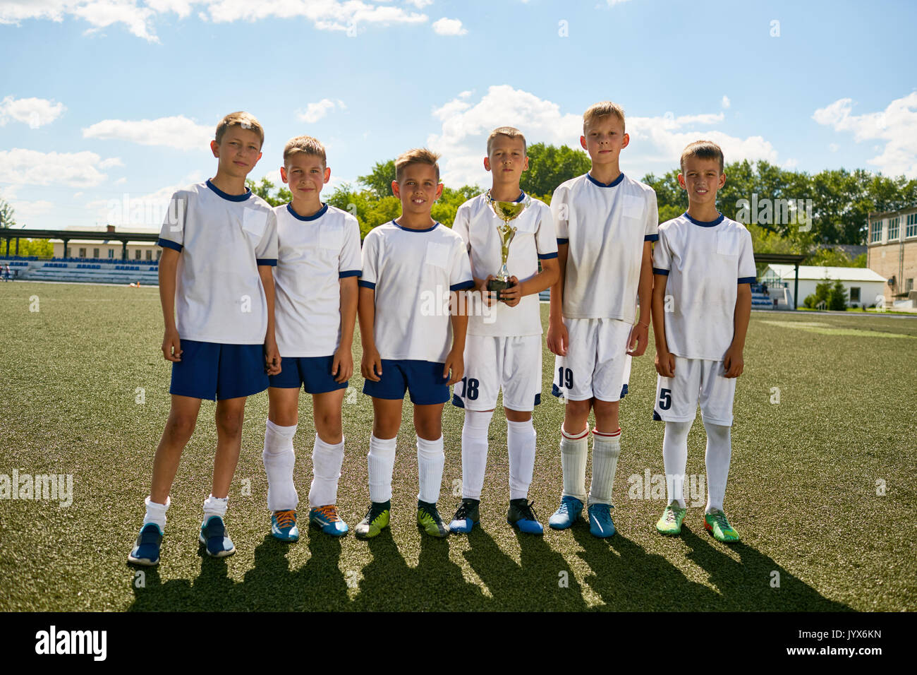 Junior Football Team Posing with Cup Stock Photo - Alamy