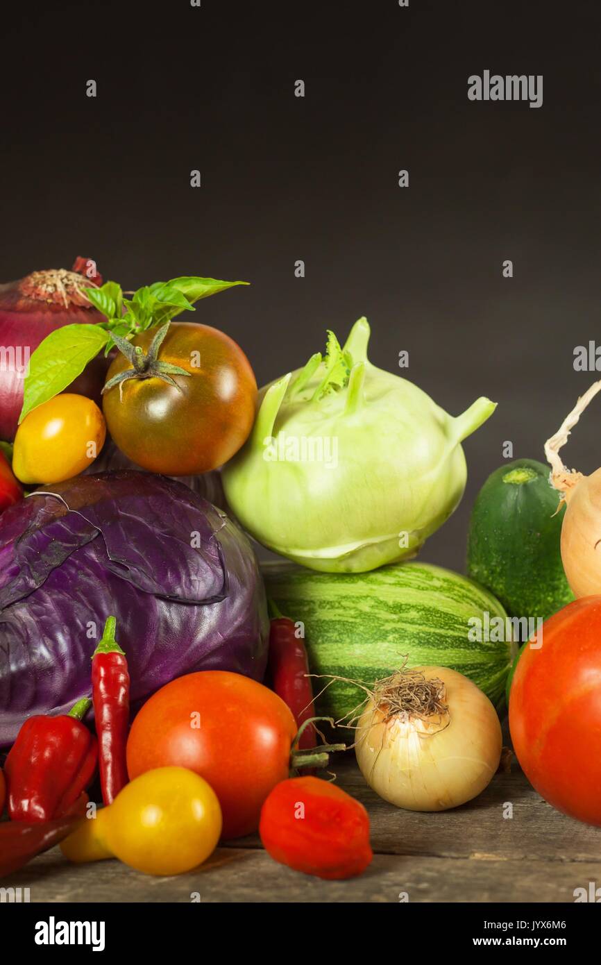 Different types of fresh vegetables on a wooden table. Harvesting ...