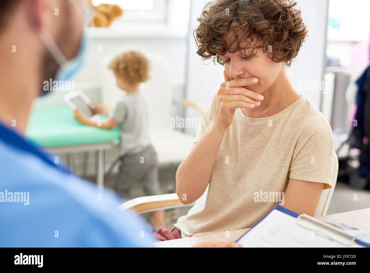 Sad Young Woman in Doctors Office Stock Photo - Alamy