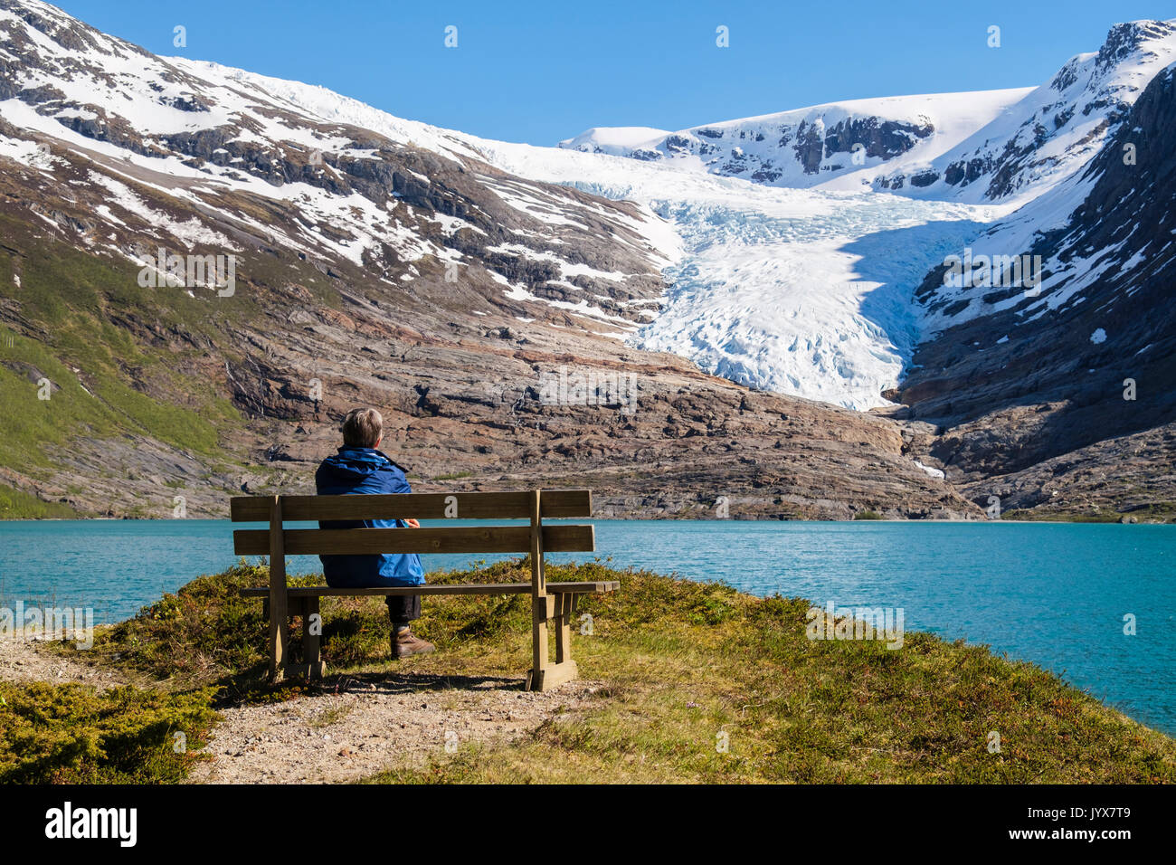 Woman looking at Engabreen or Enga glacier arm of Svartisen ice cap ...
