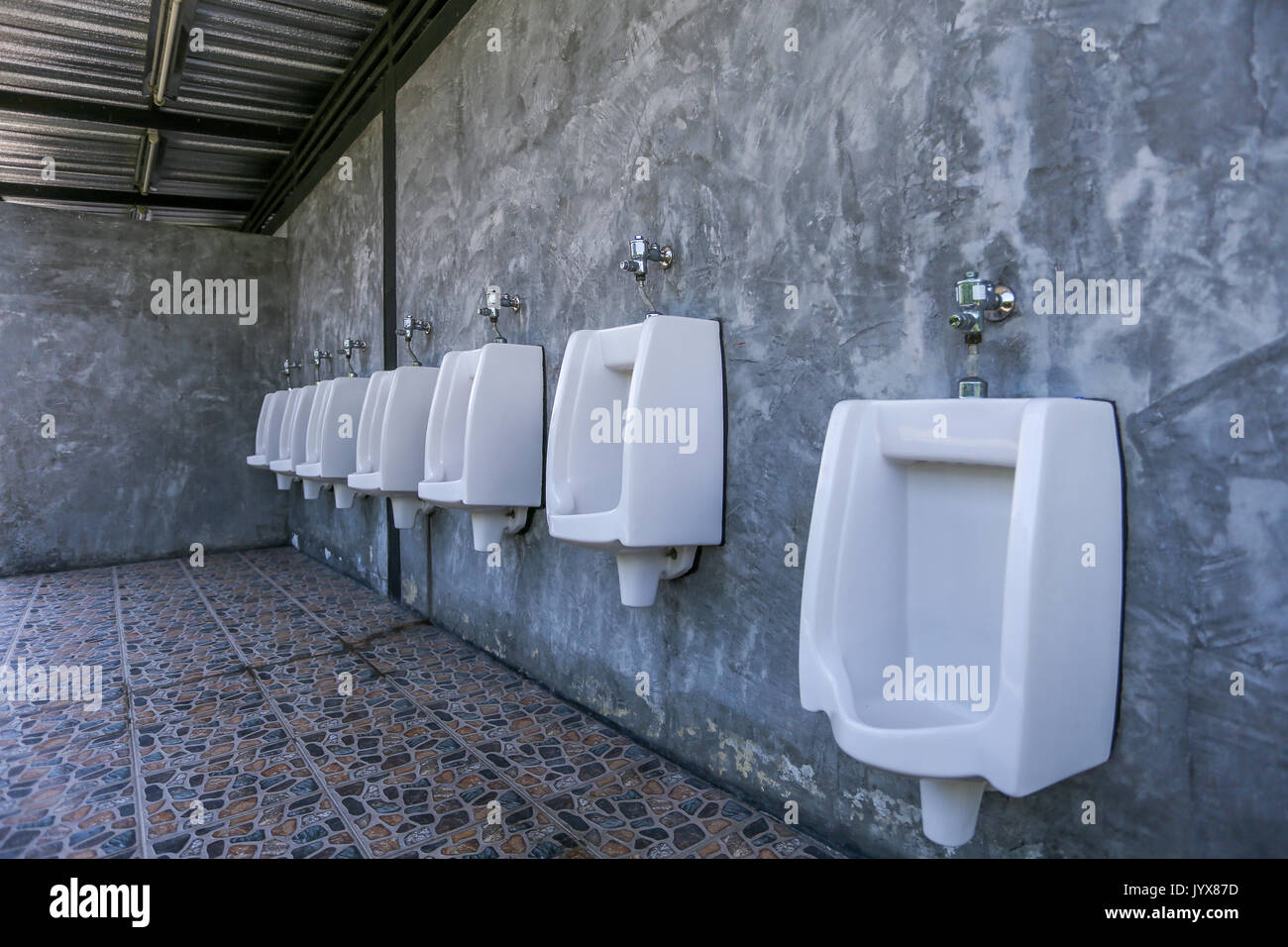 urinal row in a public restroom Stock Photo - Alamy