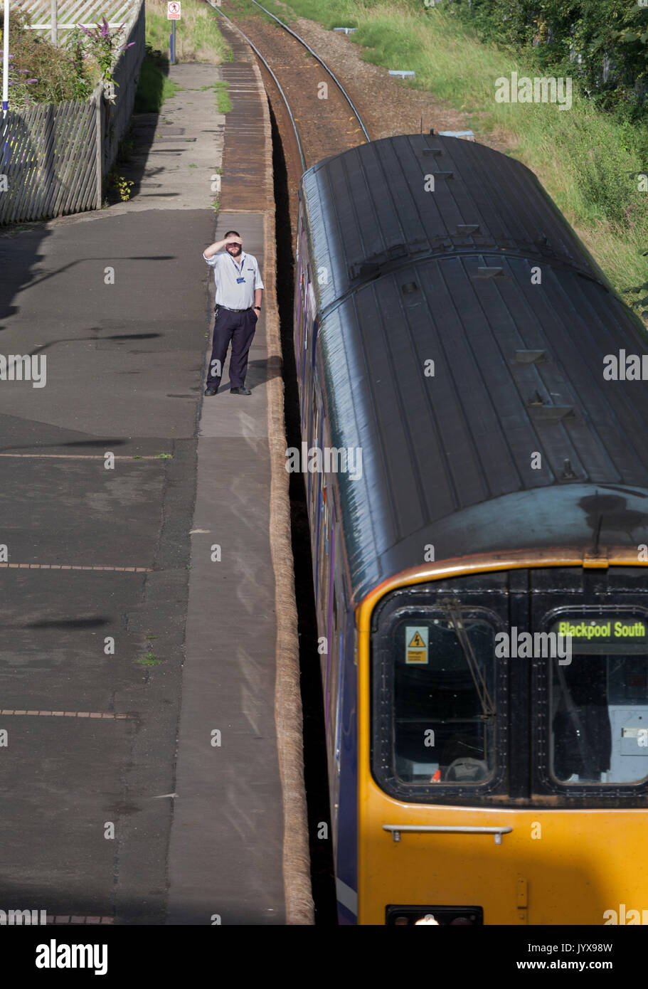 Northern rail guard / conductor working the 1721 Colne - Blackpool ...