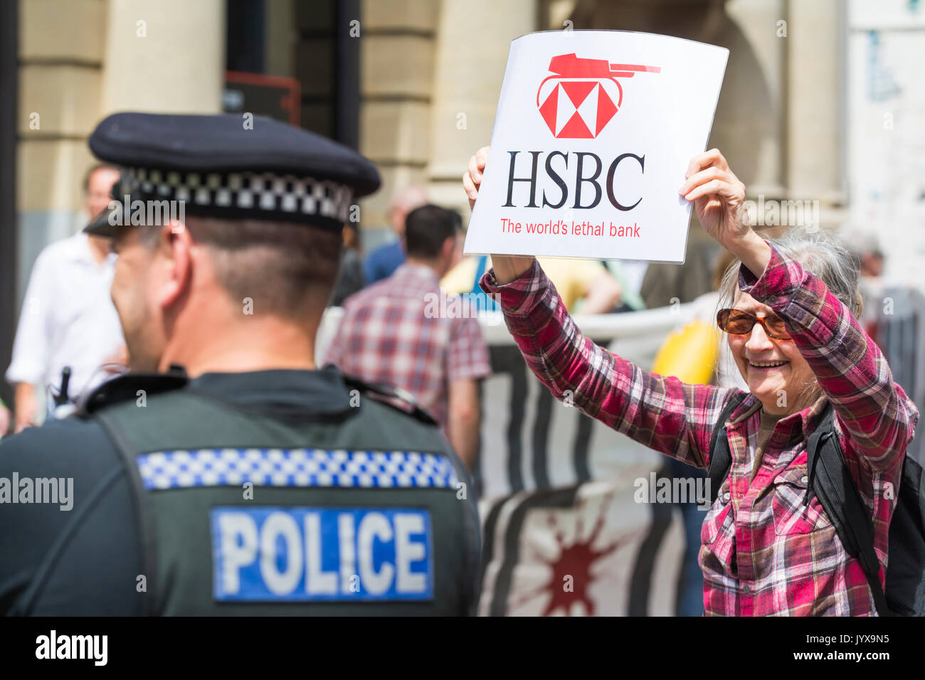 Protestor holding a protest sign up saying "Stop Arming Israel" outside ...