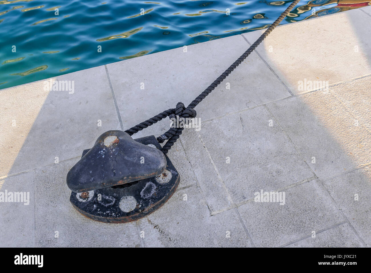 Mooring with ropes for fastening the ship to the pier Stock Photo - Alamy