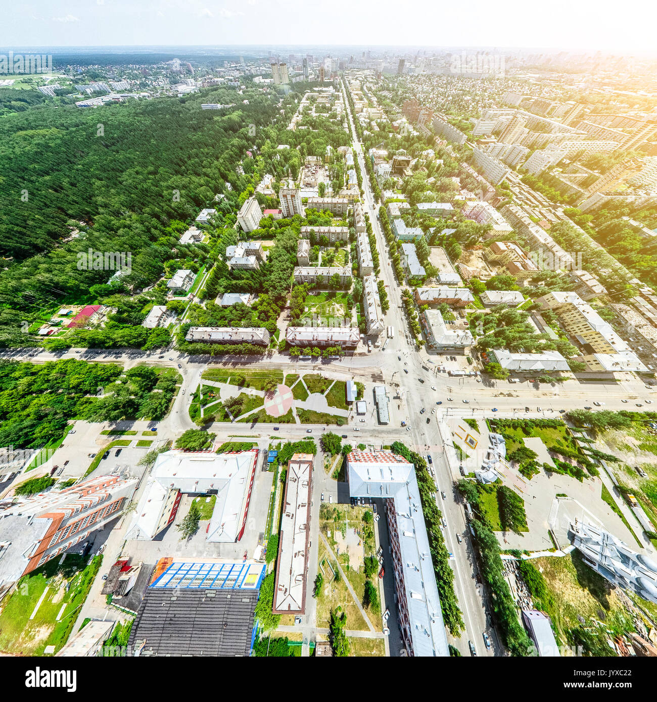 Aerial city view with crossroads and roads, houses, buildings, parks ...