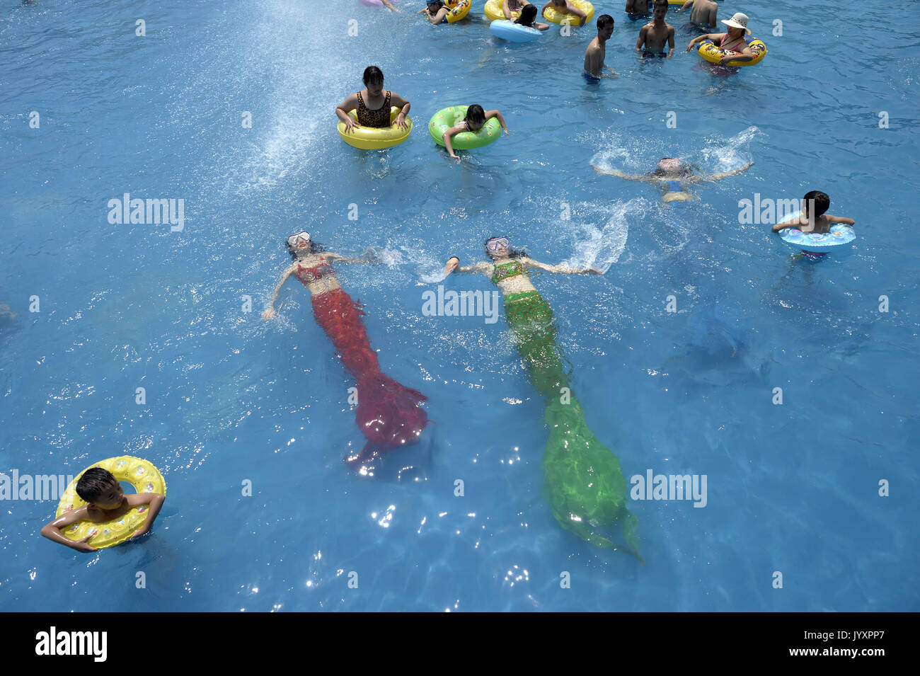 Chongqin, China. 21st Aug, 2017. Women wearing costumes of mermaids ...