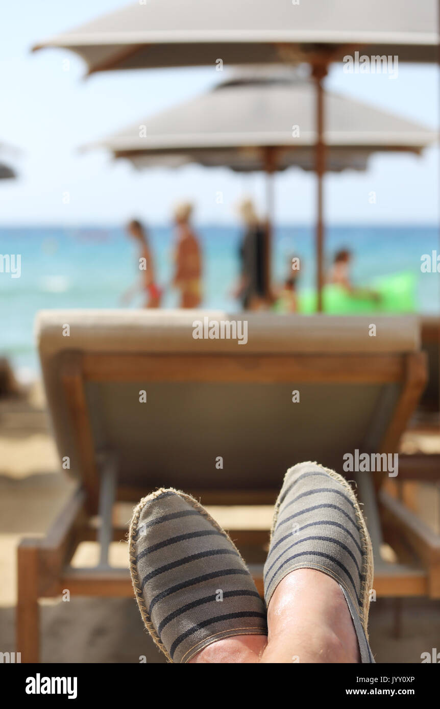 feet on beach lounger Stock Photo - Alamy