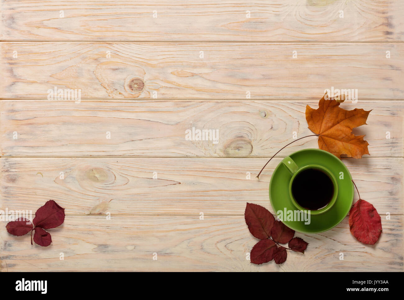 Fall concept. Cups of coffee and autumn leaves on a light wooden ...