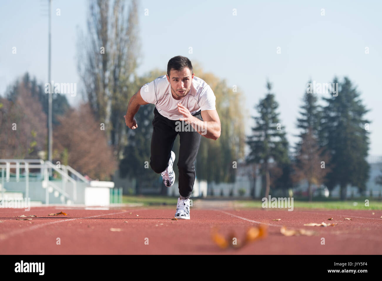 Attractive Man Sprinting on the Running Track in City Park Area ...