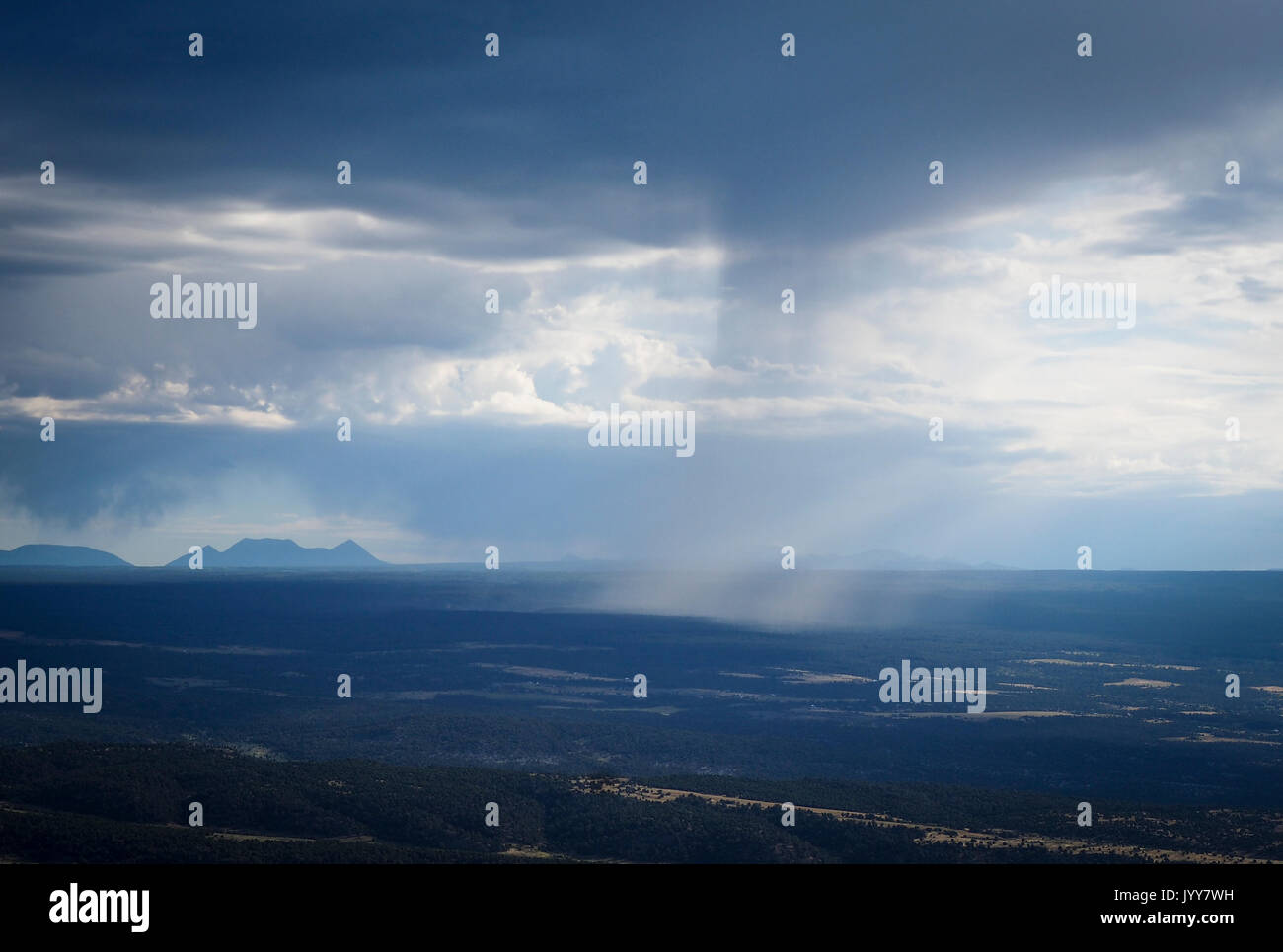 Local rain showers from cumulus nimbus clouds are falling onto the ...