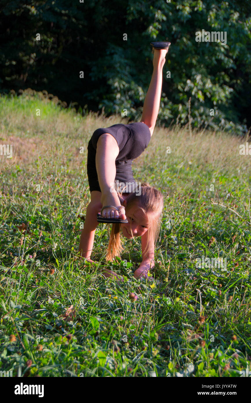 A little girl make hand stand, front walkover, back walkover, cartwheel ...
