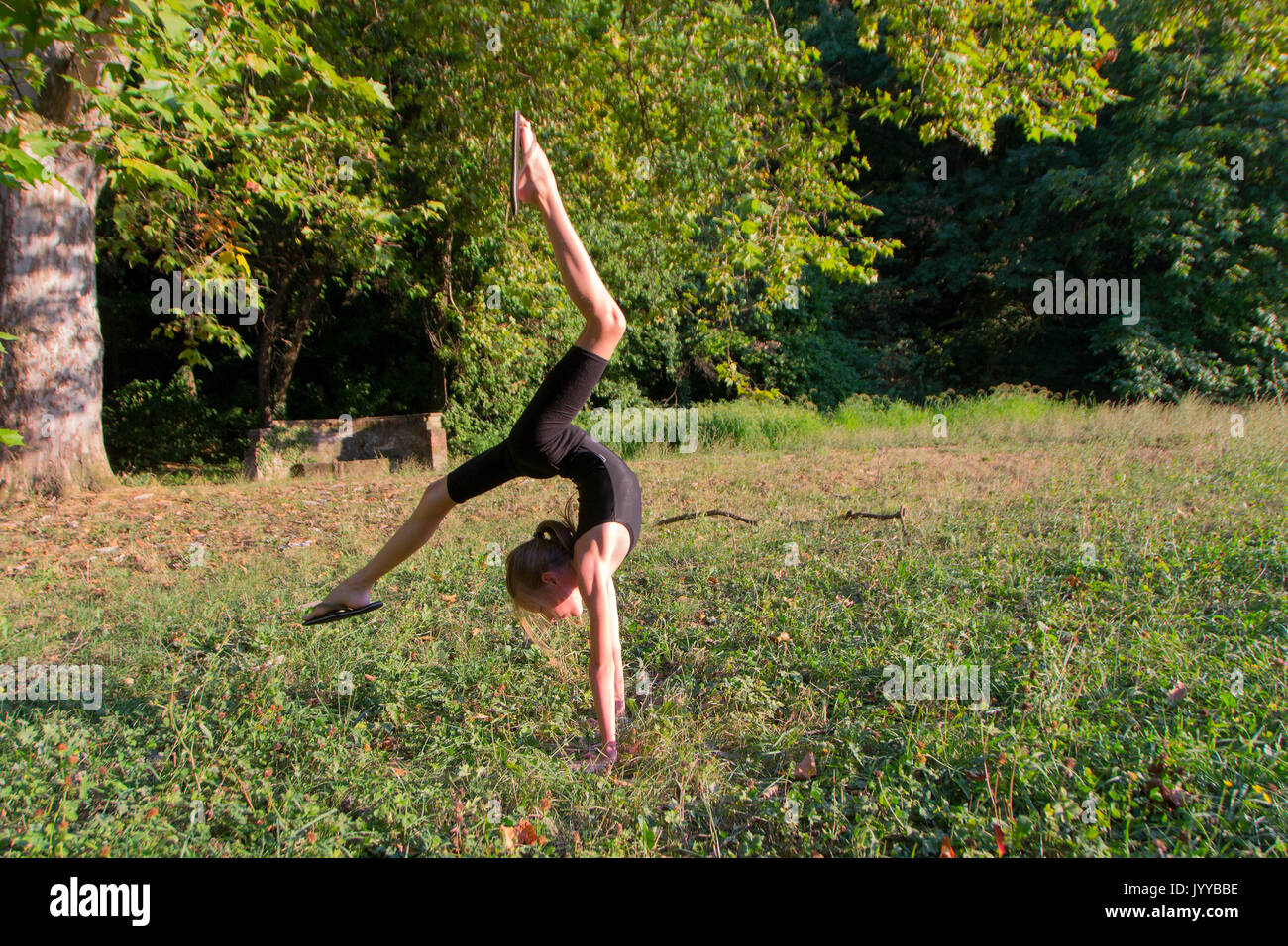 A little girl make hand stand, front walkover, back walkover, cartwheel ...