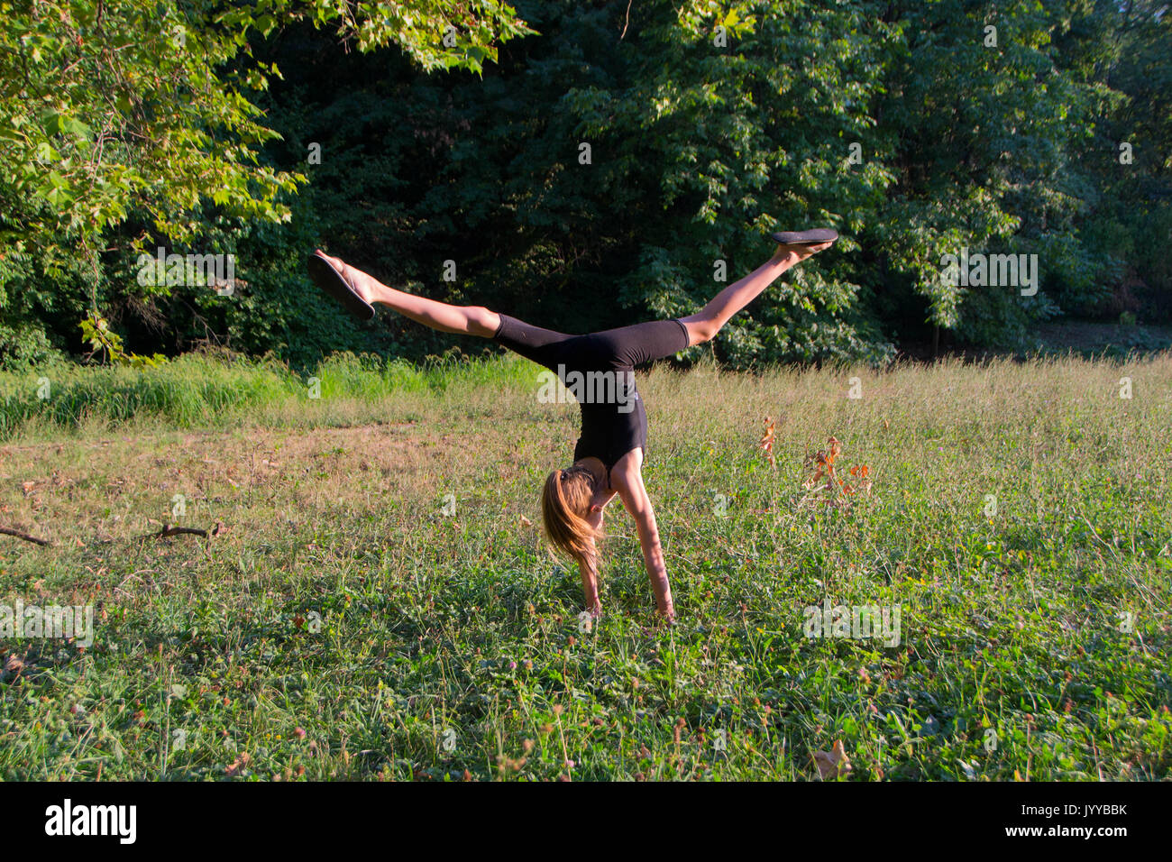 A little girl make hand stand, front walkover, back walkover, cartwheel ...